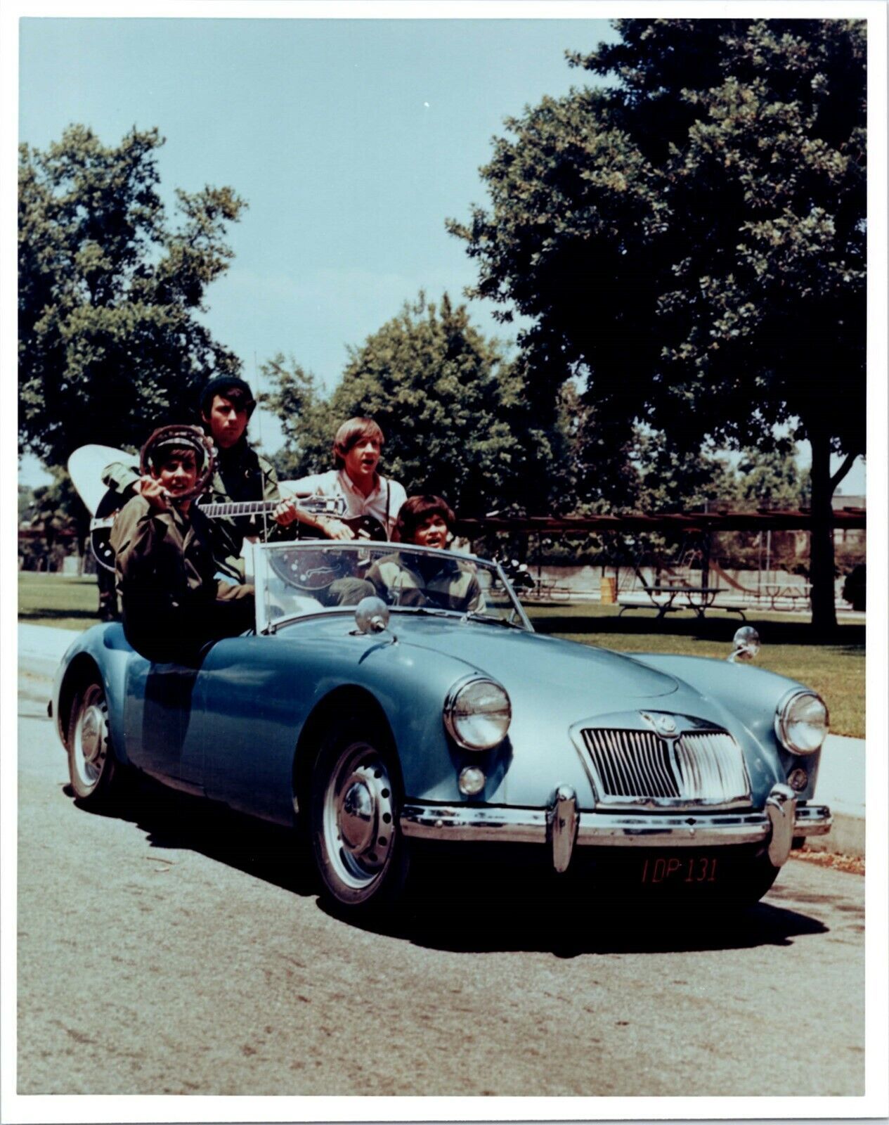 The Monkees vintage 8x10 photo playing guitars seated in MG sports car ...