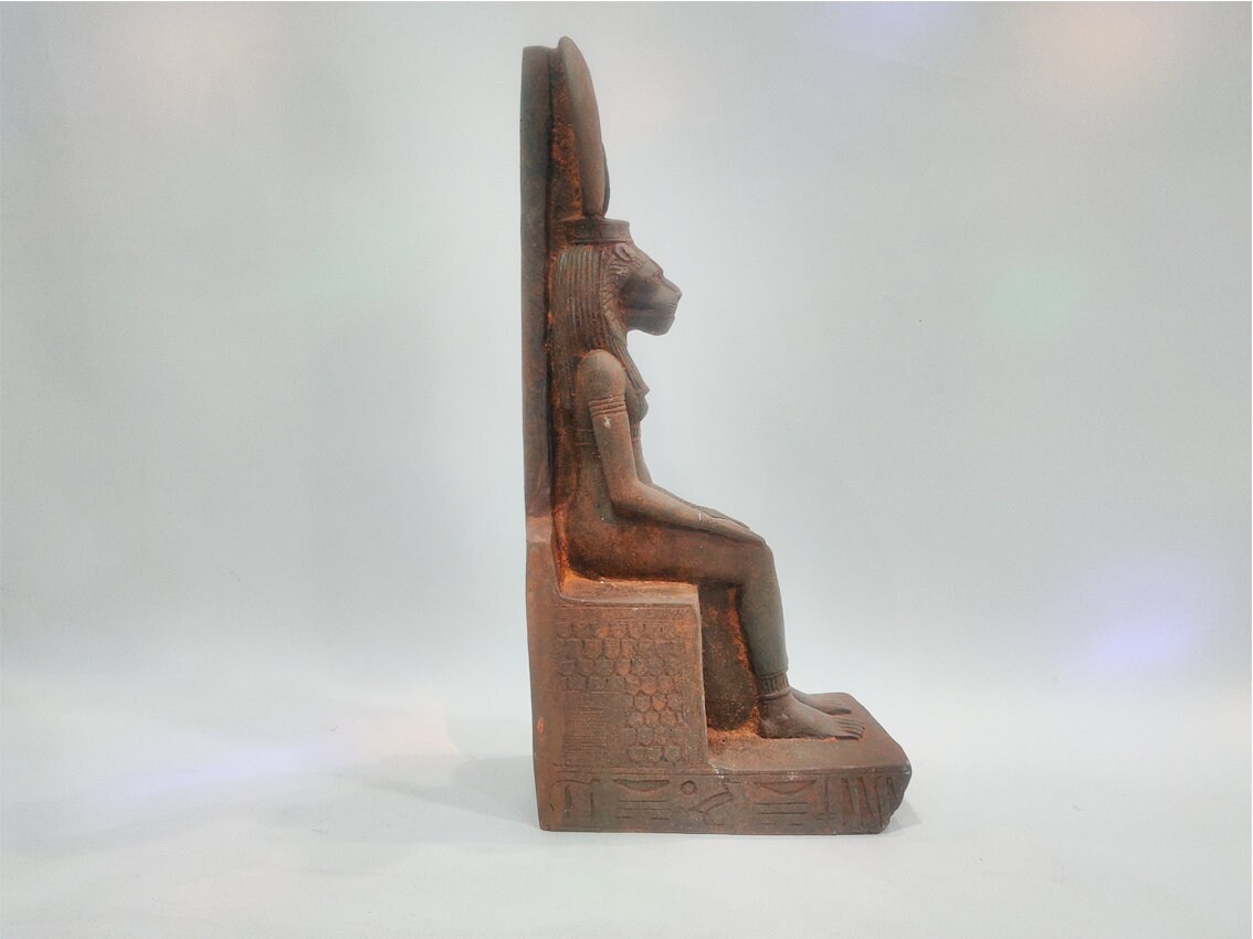 A seated statue of the goddess Sekhmet of solid stone. A rare museum ...