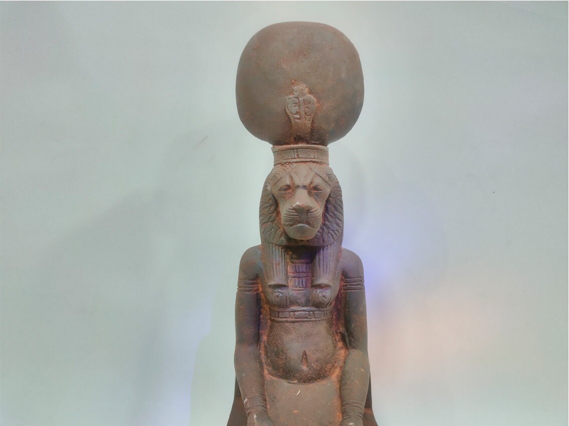 A seated statue of the goddess Sekhmet of solid stone. A rare museum ...