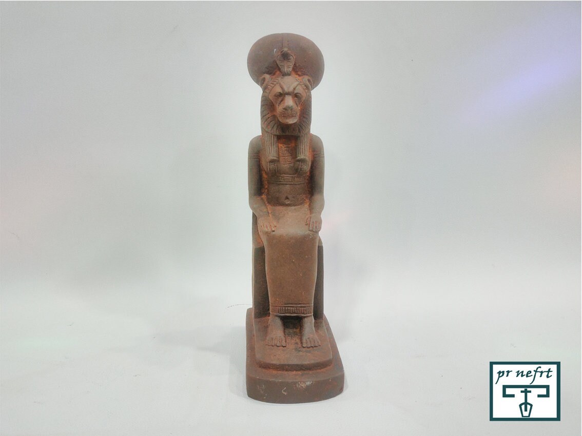 A seated statue of the goddess Sekhmet of solid stone. A rare museum ...