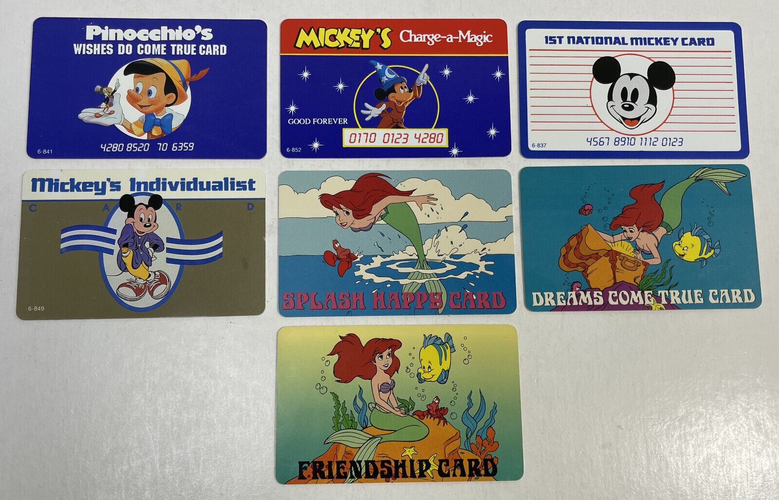 Lot of 7 Disney Cards, Little Mermaid, Mickey Mouse, Pinocchio, Charge ...